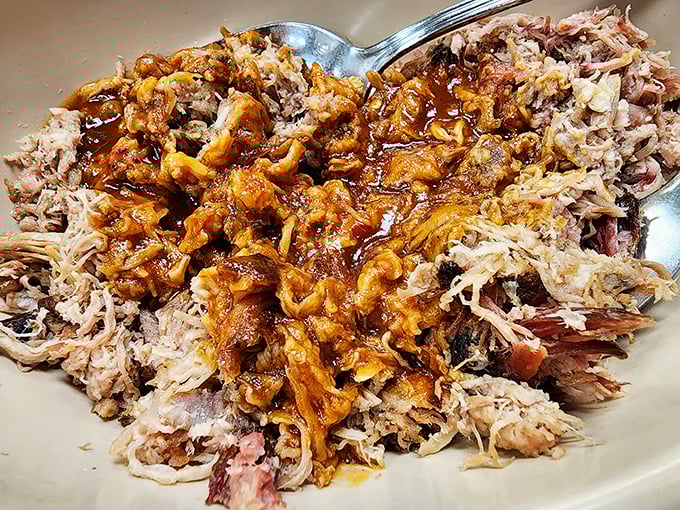 BBQ pulled pork that doesn't just fall apart—it practically surrenders to your fork, waving a delicious sauce-soaked white flag of culinary capitulation.