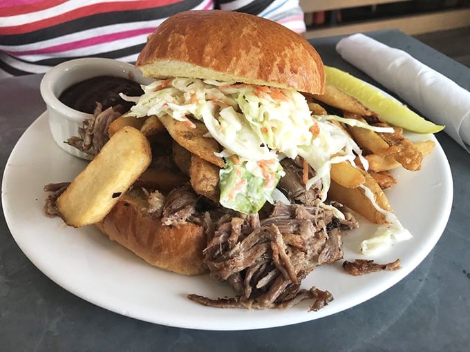 This pulled pork sandwich isn't just lunch—it's an architectural marvel of meat, slaw, and crispy fries.