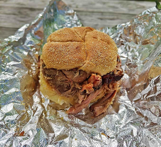The pulled pork sandwich arrives like a meaty treasure wrapped in foil, with tender strands of smoke-kissed pork practically begging to meet your taste buds.
