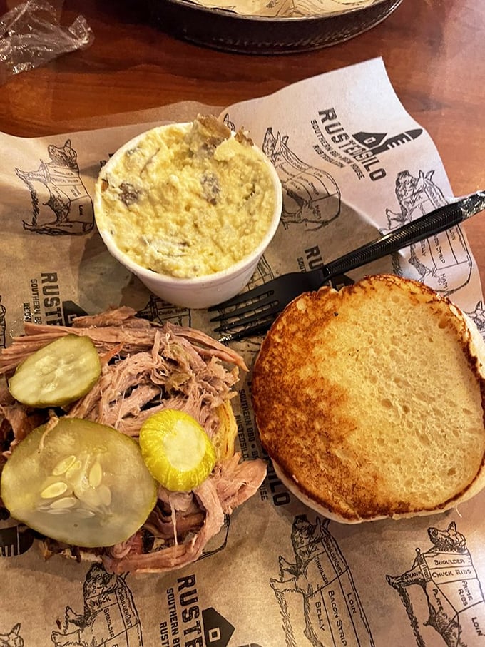 This pulled pork sandwich, adorned with pickles and paired with mac and cheese, isn't just lunch—it's an edible love letter to Southern tradition.