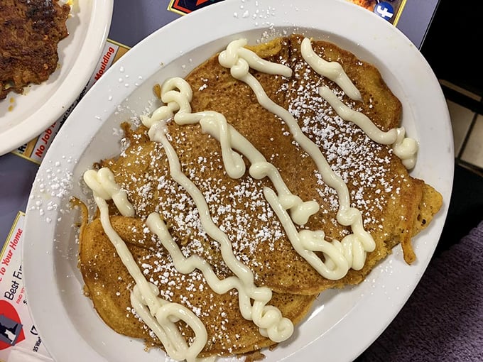 These pancakes aren't just drizzled—they're lovingly painted with cream cheese glaze, like Jackson Pollock decided to become a breakfast chef.