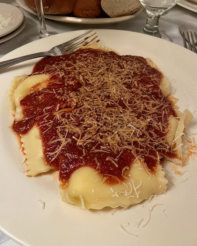 Ravioli bathed in that signature red gravy and showered with cheese—like little pasta pillows having the best day of their lives.