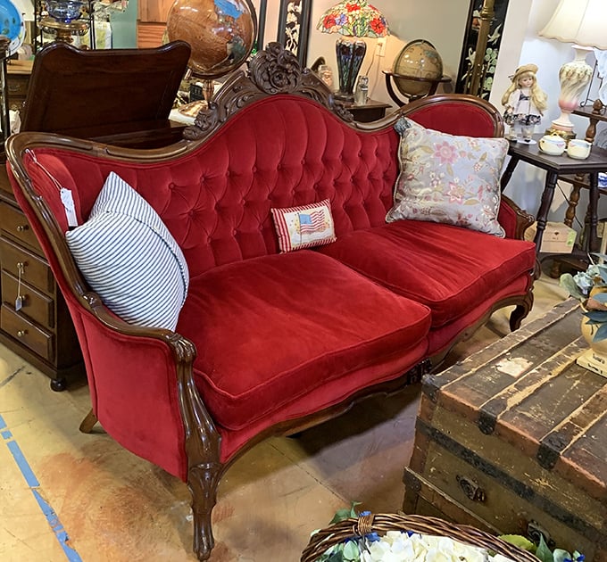 That red velvet Victorian sofa isn't just furniture—it's a statement piece that whispers, "Yes, you ARE fancy enough to own me."
