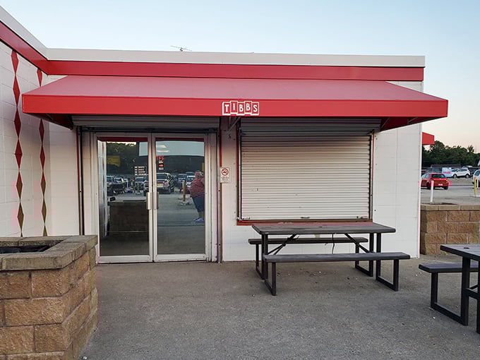The red awning and picnic tables welcome hungry moviegoers. This isn't just a concession stand—it's intermission headquarters.