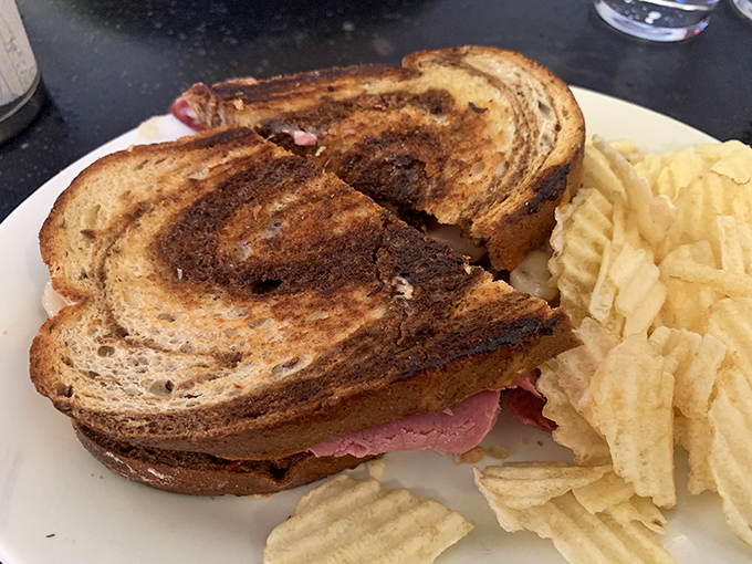 Marbled rye, tender meat, melted cheese—this sandwich doesn't need a passport to transport you straight to delicatessen heaven.