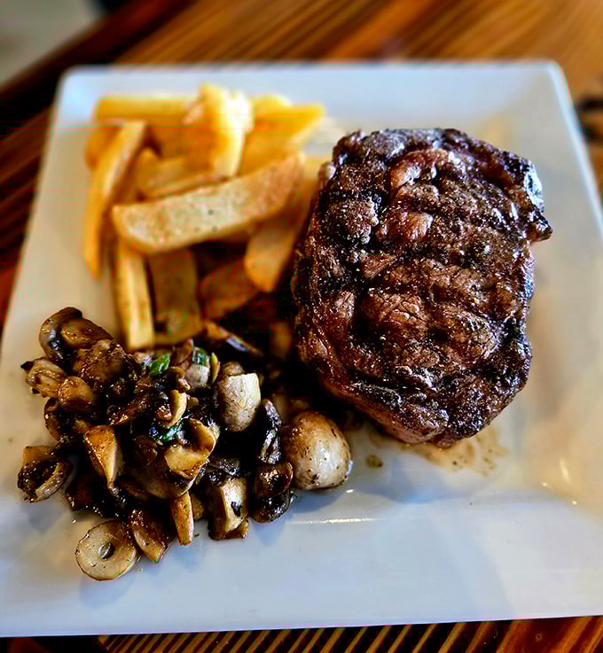 Behold the steak that launched a thousand food dreams – a perfectly seared filet with mushrooms that have clearly found their life's purpose.