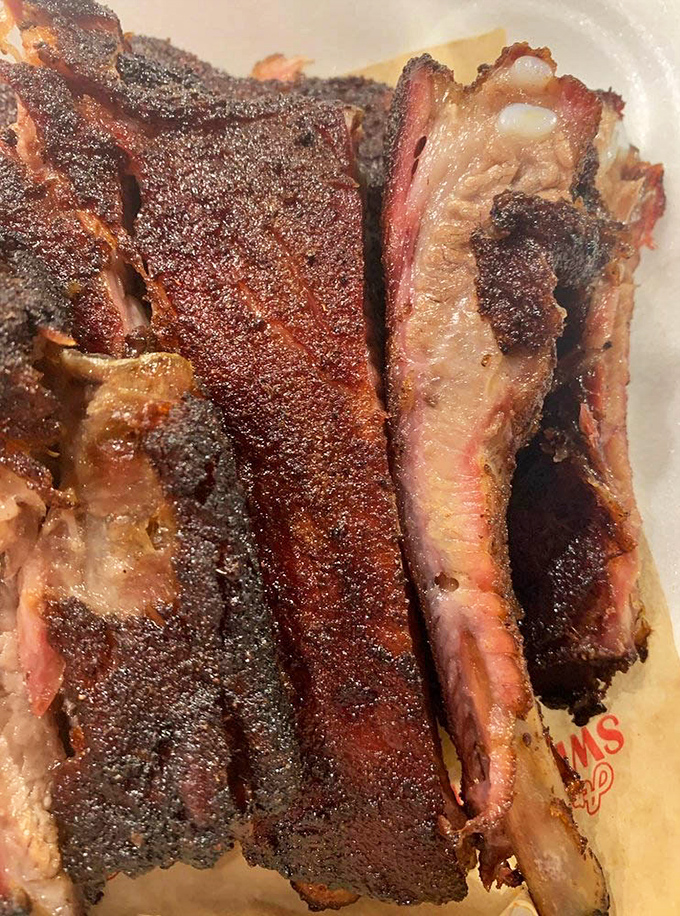 These ribs have that perfect "tug"—not falling off the bone (that's overcooked, folks) but releasing with just enough resistance to know you're eating something special.