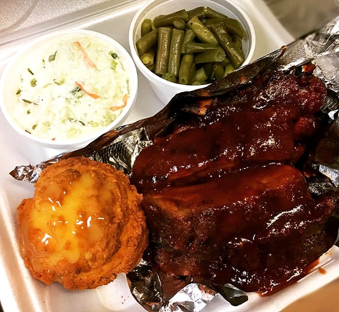 Barbecue ribs that fall off the bone with less resistance than I show to dessert menus. That cornbread and slaw aren't just sides – they're supporting actors deserving their own award.