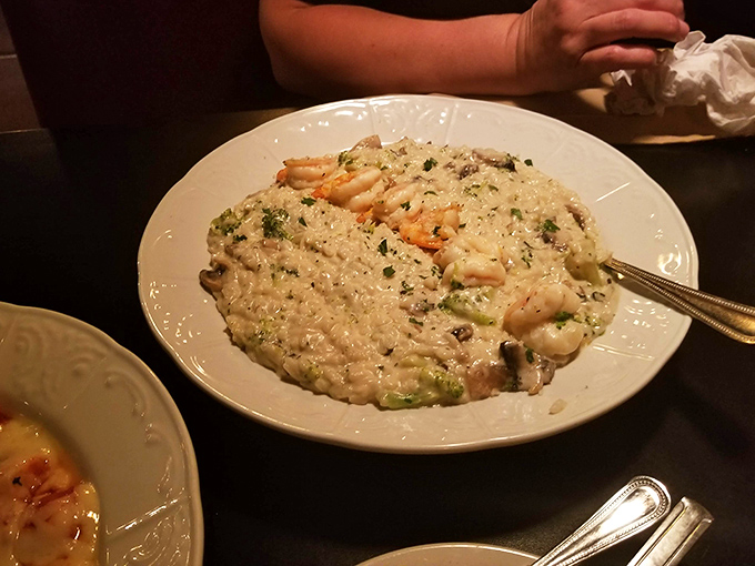 Risotto that doesn't just sit on the plate but performs – creamy, studded with plump shrimp, and demanding your undivided attention with every forkful.