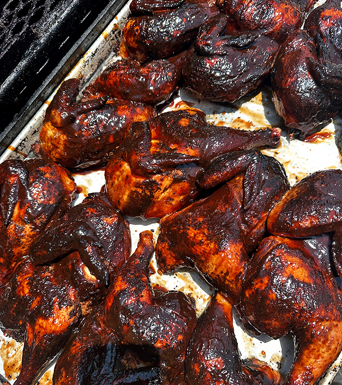 These BBQ chicken pieces aren't just cooked, they're transformed – glistening with sauce and sporting that perfect char that makes you want to lick your fingers clean.