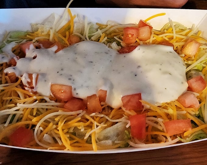 A salad that doesn't apologize for being delicious. That creamy dressing cascading over fresh ingredients proves healthy-adjacent food can still be indulgent. 