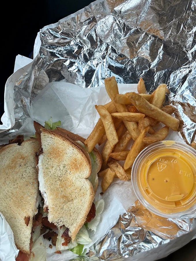 The classic cheesesteak with fries – a pairing so perfect it should have its own national holiday. That cheese sauce? Liquid gold.