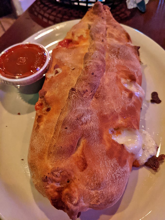 The sausage roll arrives like an edible love letter from the kitchen, with that golden-brown crust hiding a savory treasure within. The side of sauce is merely a formality.