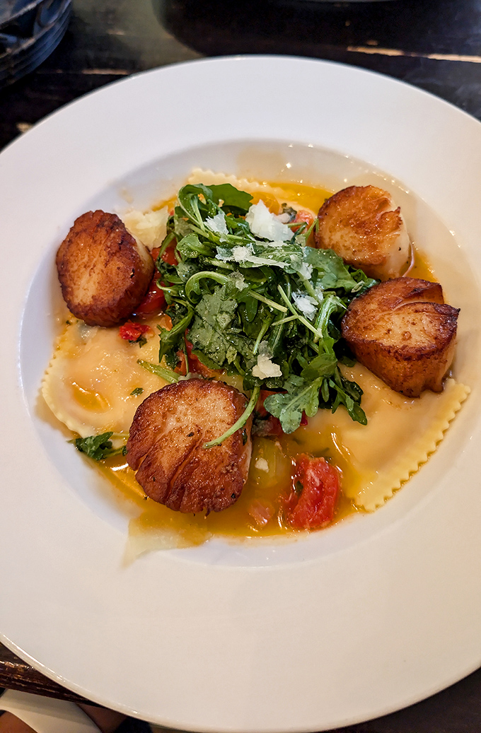 These seared scallops aren't just dinner—they're little golden discs of ocean perfection dancing around pasta like they own the place.