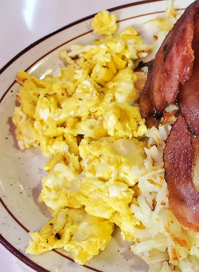 Scrambled eggs that actually taste like eggs—what a concept! Paired with bacon cooked to that perfect spot between chewy and crisp.