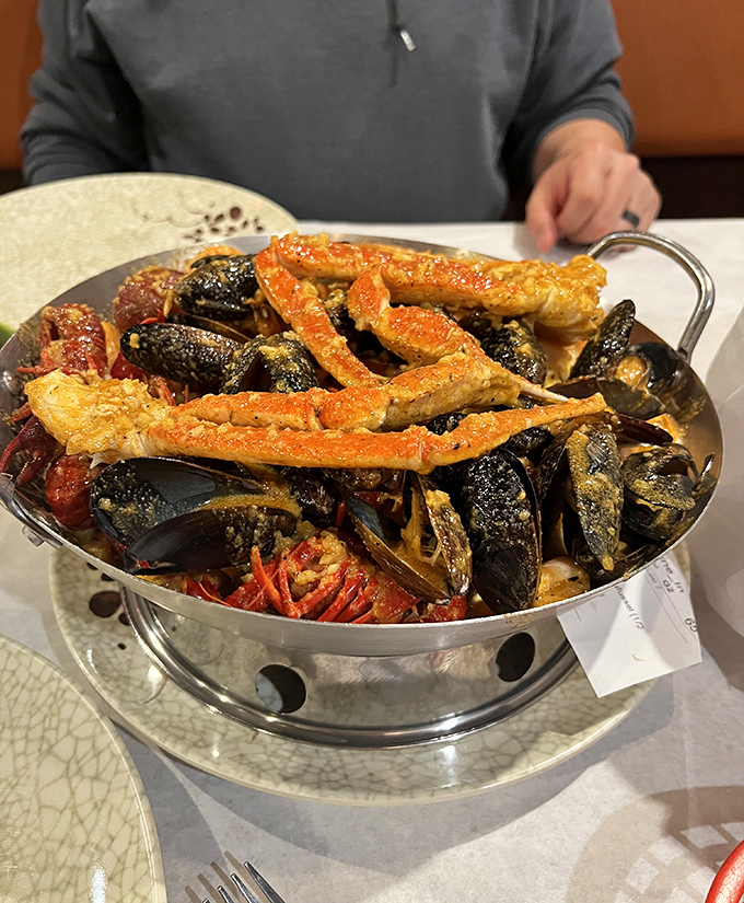 A seafood boil that's practically a treasure chest—crab legs, mussels, and more, all glistening with seasoned goodness.