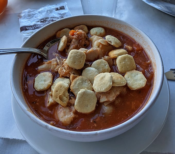 A bowl of seafood chowder topped with oyster crackers—comfort food that tastes like the ocean gave you a warm hug.
