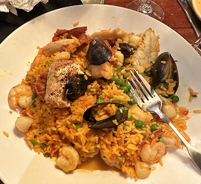 Seafood Paella that's worth the trip alone – a treasure chest of ocean delights nestled in saffron-kissed rice that whispers "vacation" with every bite.
