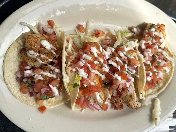 These seafood tacos aren't just Instagram-pretty—they're loaded with fresh pico de gallo and drizzled with sauce that ties everything together like a well-conducted orchestra.