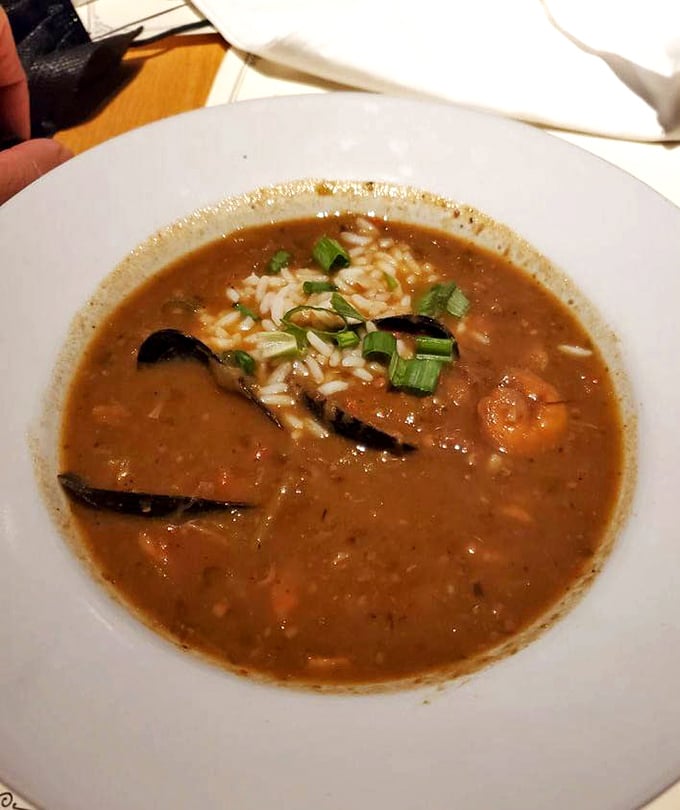 A bowl of gumbo that would make New Orleans proud—rich roux, tender seafood, and rice that's soaking up all that bayou goodness.
