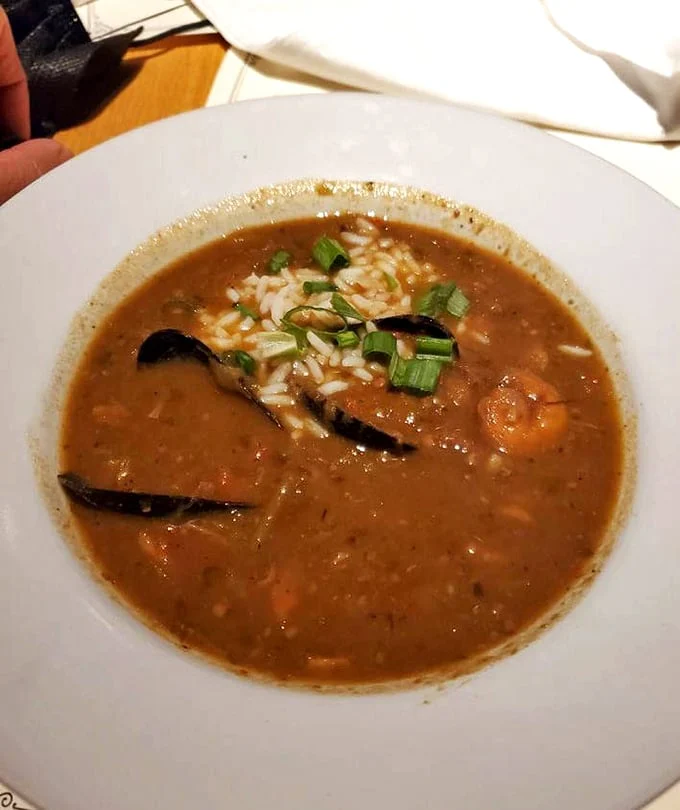 A bowl of gumbo that would make New Orleans proud—rich roux, tender seafood, and rice that's soaking up all that bayou goodness.