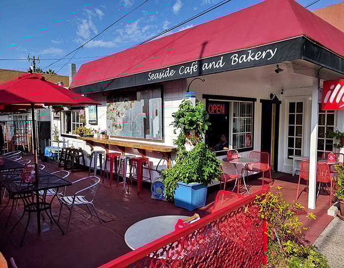 This little red-awninged Seaside Café isn't just charming – it's the kind of place where locals nod knowingly when tourists accidentally discover their secret breakfast spot.