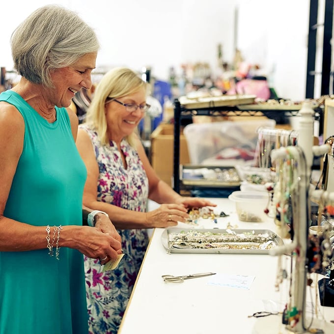 The jewelry counter brings together shoppers sharing the universal thrill of the find—where vintage brooches and contemporary pieces await new owners.