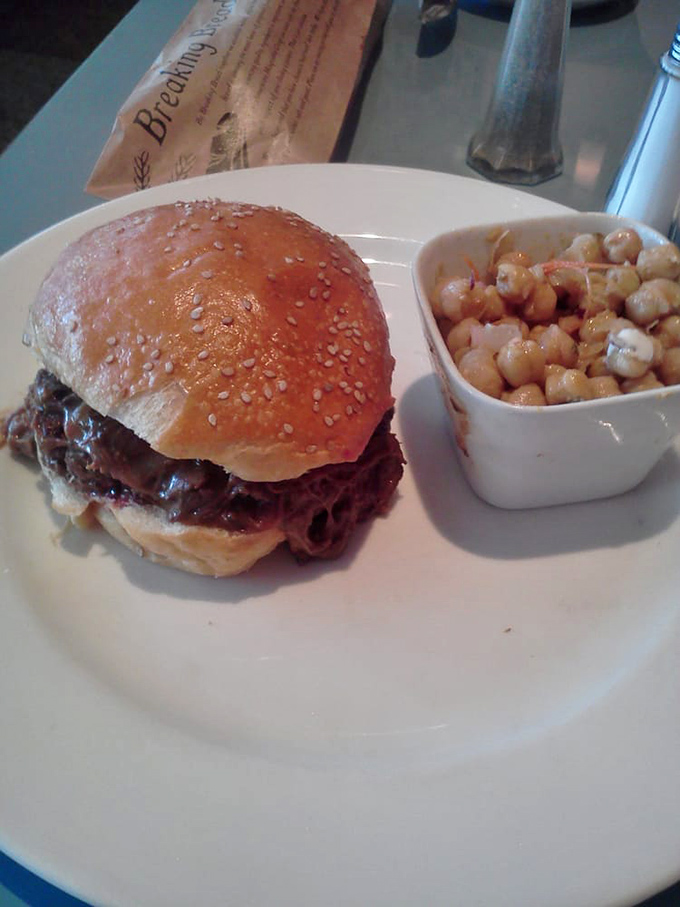 Short rib burger perfection with a side of mac salad – proof that comfort food can transcend to art form without losing its soul.