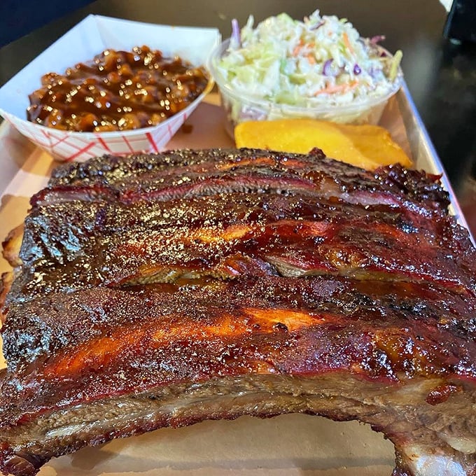 Behold the ribs—where smoke meets meat in a romance so perfect it would make Shakespeare put down his quill and pick up a napkin.