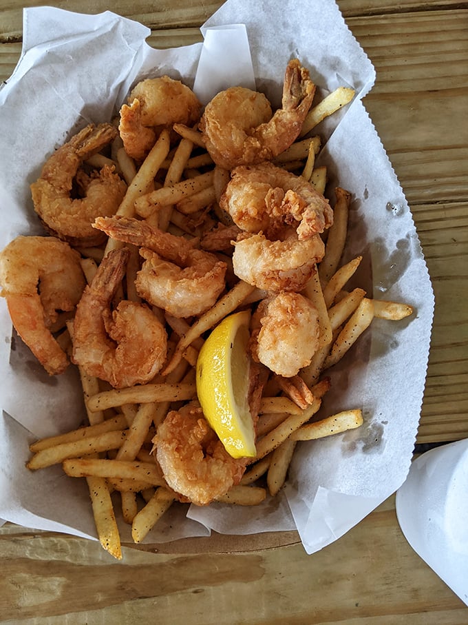 Fried shrimp nestled among french fries – a basket of golden treasures that would make Neptune himself abandon his trident for a fork.