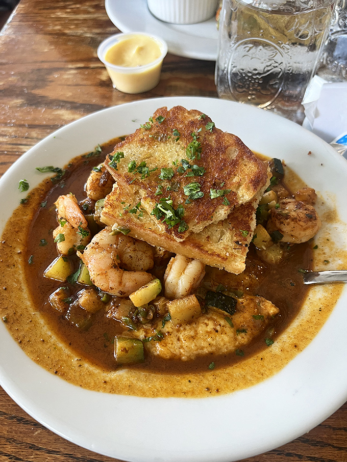 Shrimp and grits that would make a Lowcountry chef weep with joy—swimming in a sauce so good you'll contemplate drinking it directly from the bowl.