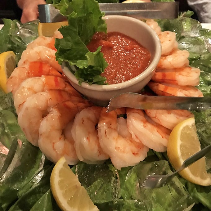 The shrimp cocktail—where each plump crustacean stands at attention around its spicy sauce companion. Ocean-fresh simplicity that makes you wonder why anyone bothers with complicated food.