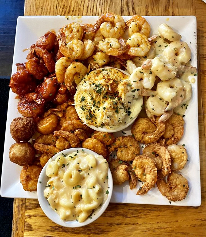 Shrimp prepared four ways surrounding creamy mac and cheese—proof that sometimes you can have it all on one magnificent plate.