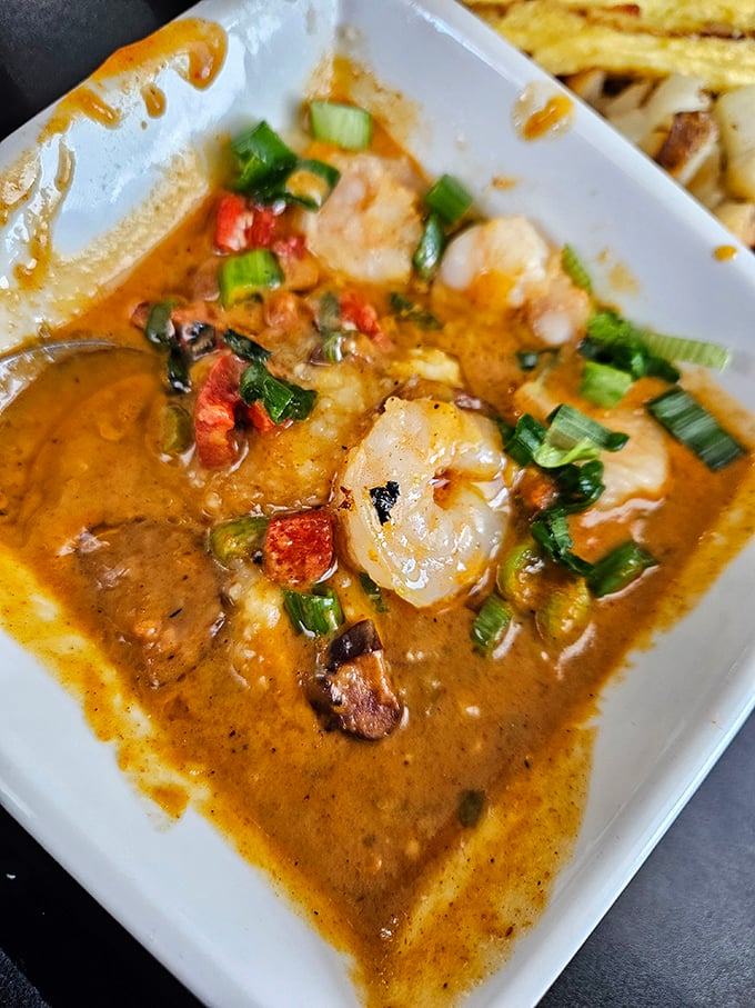 Shrimp and grits that would make a Southerner weep with joy—plump shrimp swimming in savory goodness with green onions standing guard. 