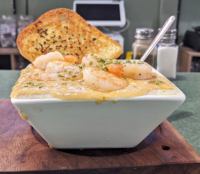 Shrimp and grits elevated to an art form. Those plump shrimp aren't just swimming in cheese—they're doing the backstroke in flavor country.