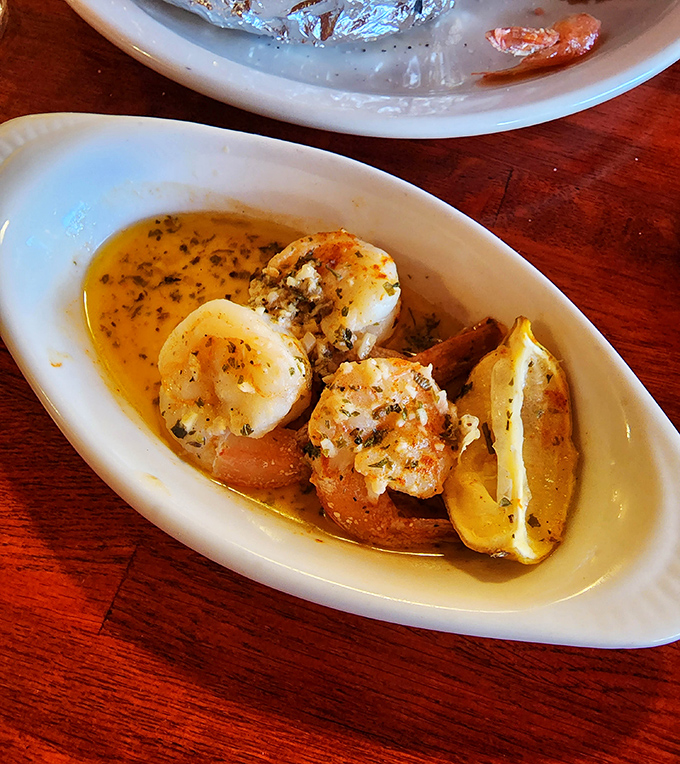 These plump shrimp bathing in buttery, herb-infused glory aren't just appetizers—they're little ambassadors of the sea, visiting your table with delicious intent.