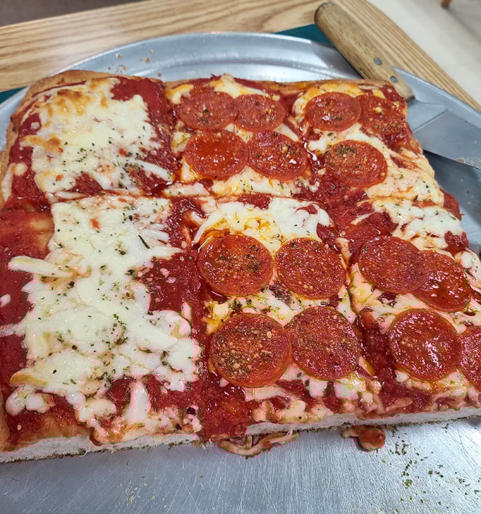 Sicilian pizza that doesn't mess around – thick, square-cut perfection with pepperoni that curls into little flavor cups. This is pizza with purpose.