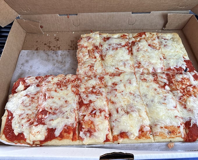 Old Forge-style pizza isn't trying to be anything but itself – rectangular, cheese-forward, and absolutely perfect for sharing (though you won't want to).