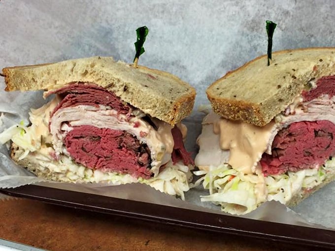 Behold the architectural marvel that is a proper deli sandwich – layers of pink perfection that would make the Empire State Building jealous.