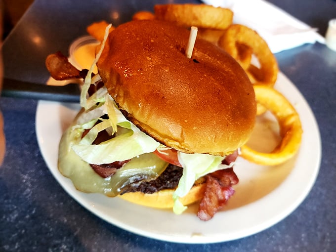 This isn't just a burger—it's architecture. A perfectly balanced tower of beef, cheese, and fresh toppings that makes fast food chains weep with inadequacy.