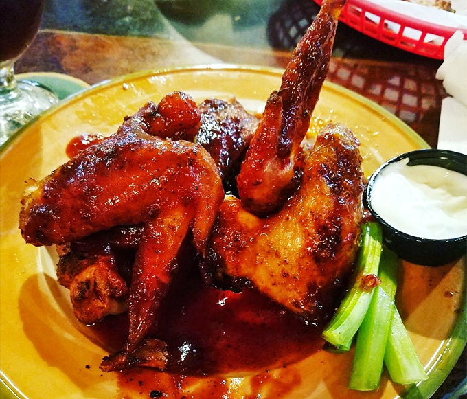 Wings that have clearly been introduced to smoke before meeting sauce. That glistening glaze isn't just for show—it's flavor you can see.