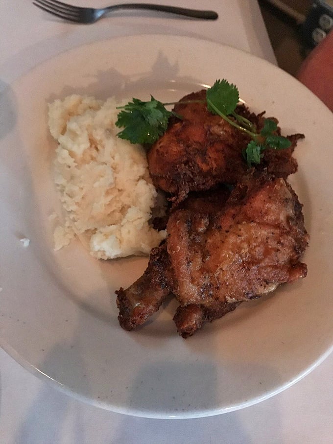 Southern fried chicken and mashed potatoes – comfort food elevated to art form. That crispy exterior shatters with promise while hiding juicy perfection beneath.