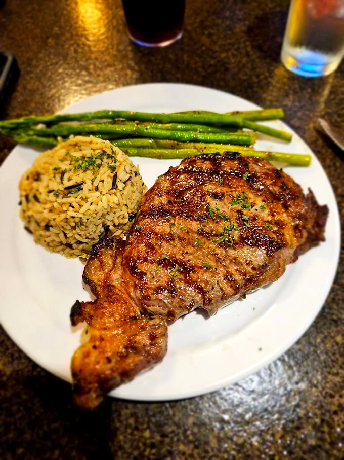 A perfectly grilled steak with just the right char marks, tender asparagus, and seasoned rice—the holy trinity of supper club perfection.