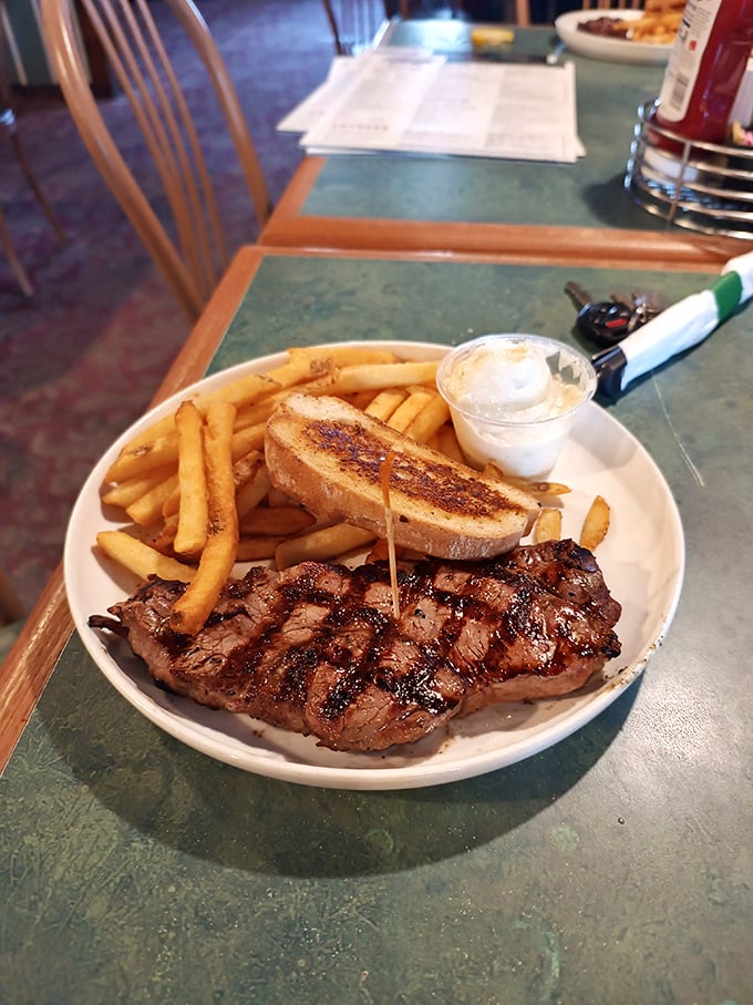 A perfectly grilled steak with golden fries and Texas toast—proof that sometimes the simplest pleasures are the most profound.