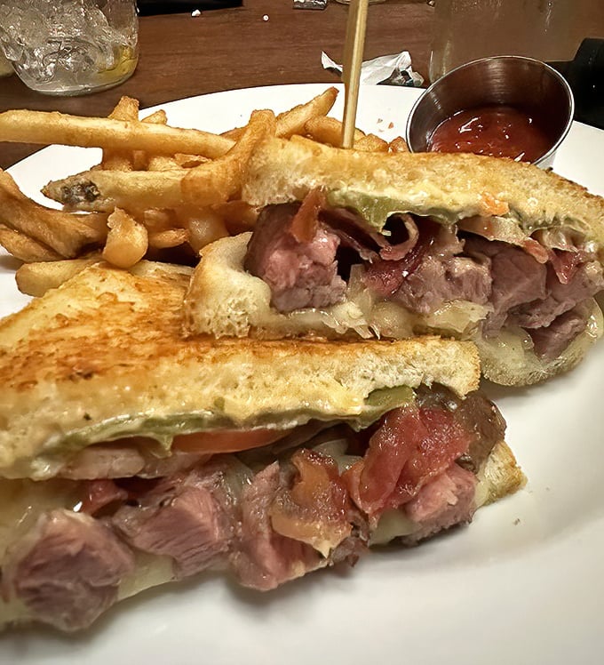 Not just any steak sandwich—this is architecture you can eat, where each layer contributes to a symphony of flavors that demands both hands and napkins.