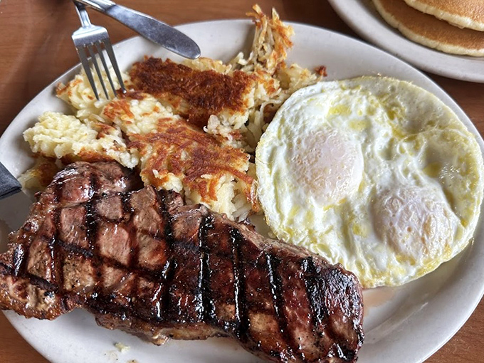 When breakfast goes bold – a perfectly grilled steak with eggs and hash browns that would make Ron Swanson weep with joy.