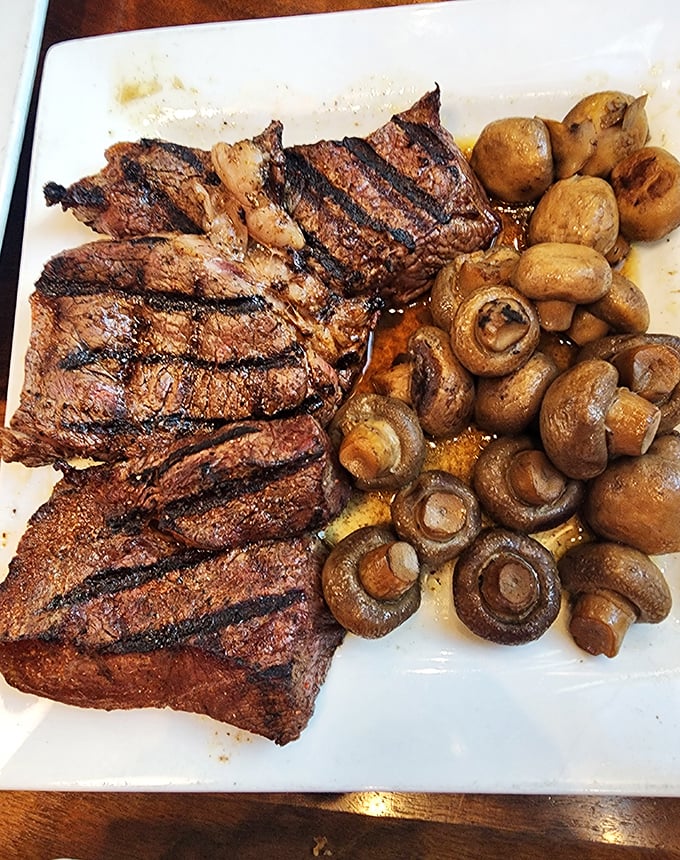A perfectly grilled steak with those coveted grill marks, accompanied by sautéed mushrooms—proof that sometimes the simplest combinations are the most divine.