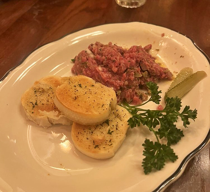 Steak tartare with toasted bread points—raw courage never looked so elegant or tasted so divine.