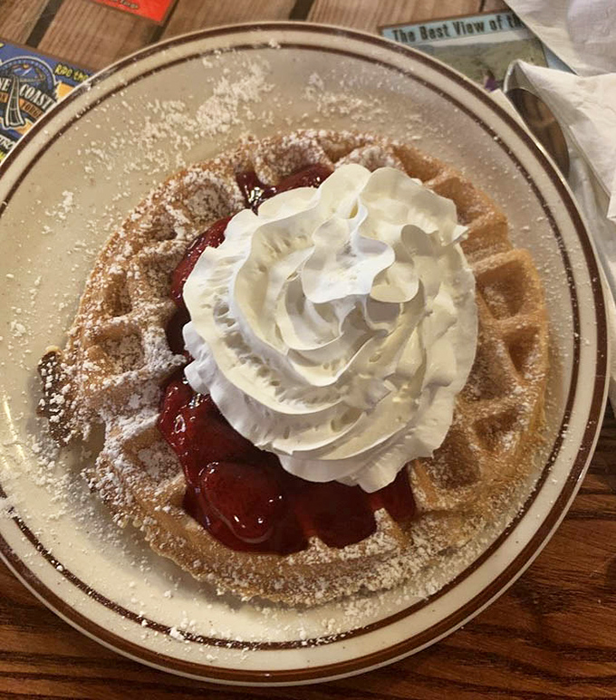 This Belgian waffle doesn't just wear its strawberries and cream—it flaunts them like a Hollywood starlet on the red carpet.