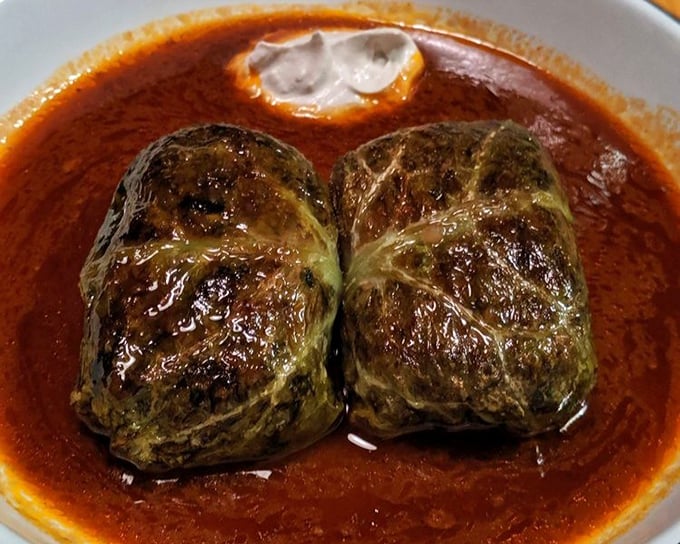 Stuffed cabbage rolls bathing in rich tomato sauce—like Eastern European comfort wrapped in a leafy green hug that warms you from the inside out.
